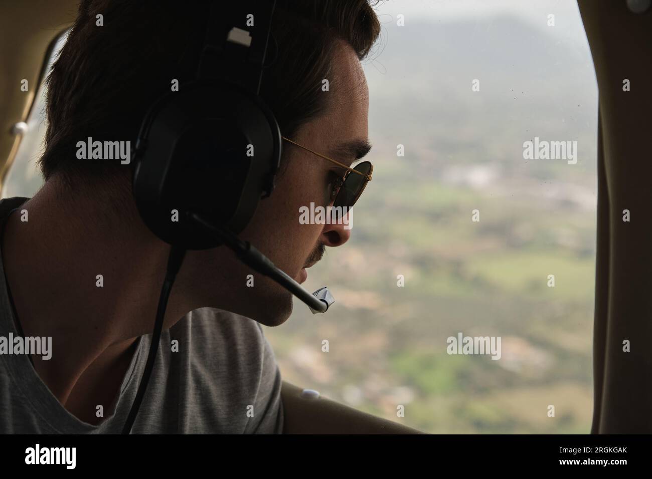 Stock photo of happy man wearing aviation headset enjoying light ...