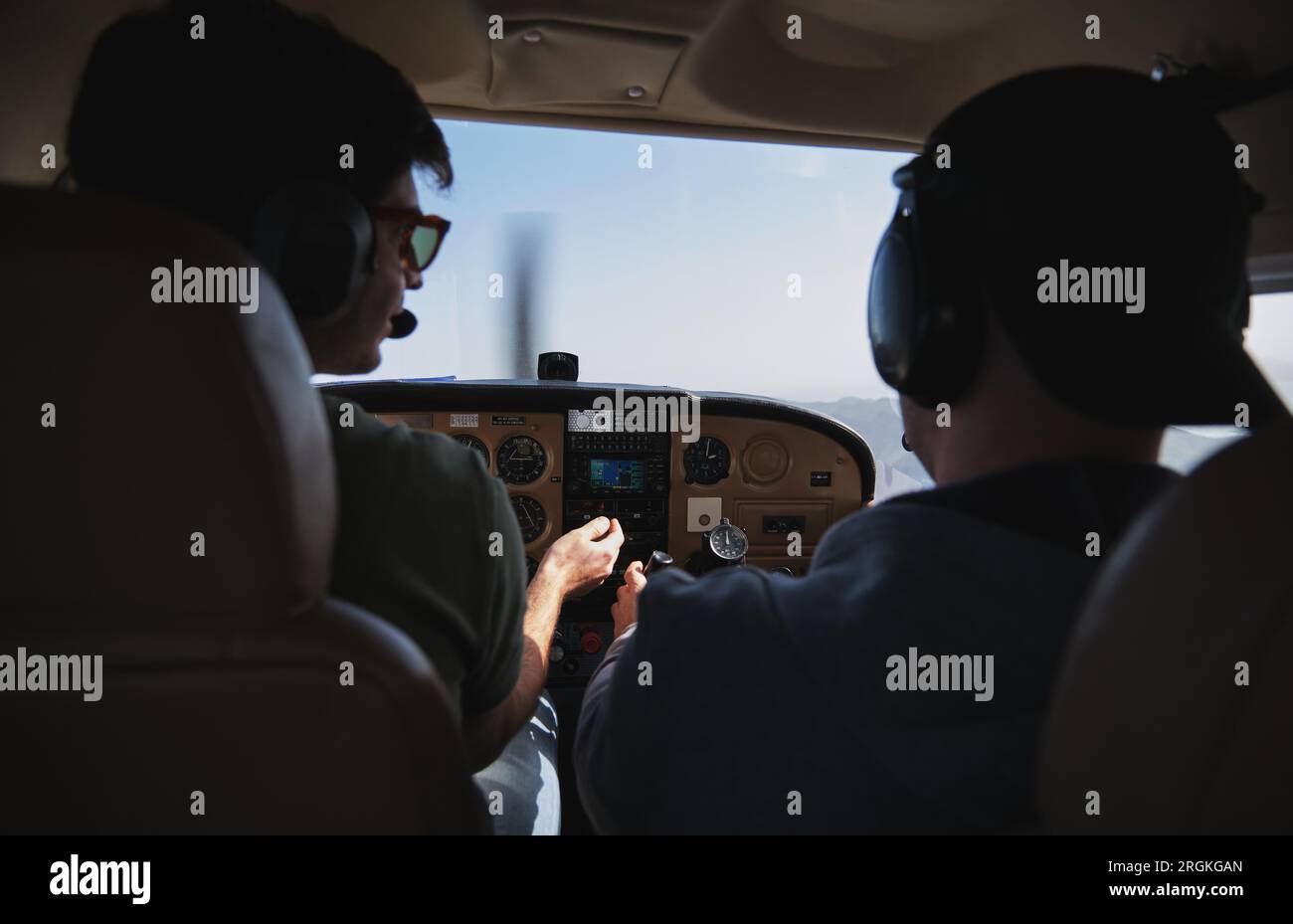 Stock photo of young man with aviation headset piloting light aircraft ...