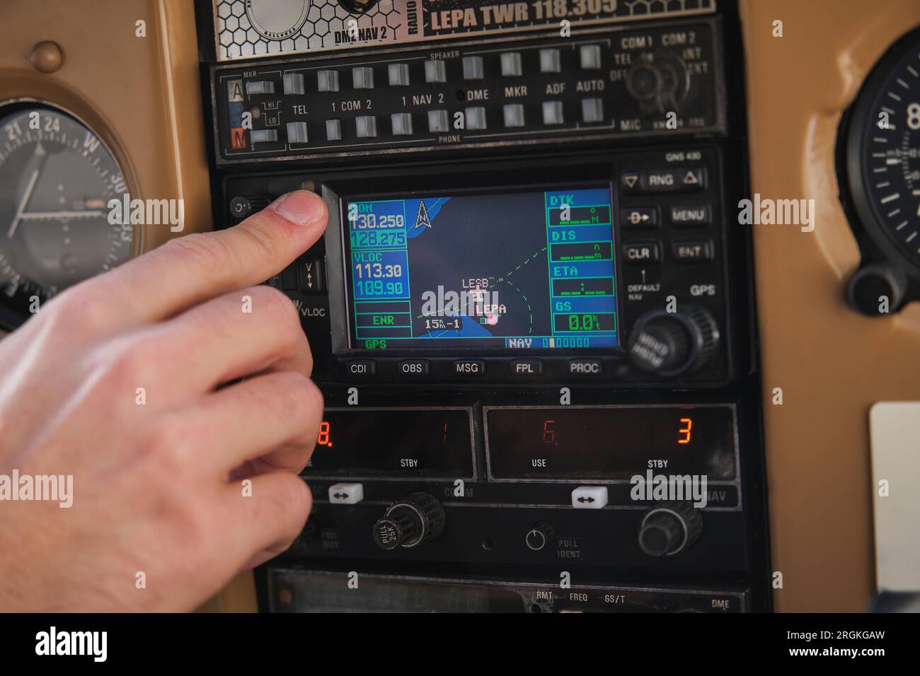 Crop unrecognizable male aviator pushing button on control panel while ...