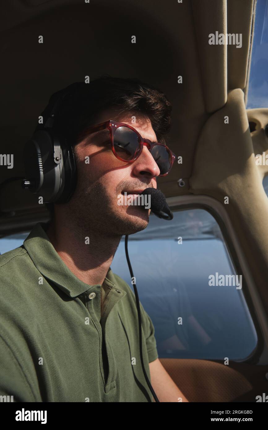 Stock photo of concentrated man with aviation headset piloting light ...