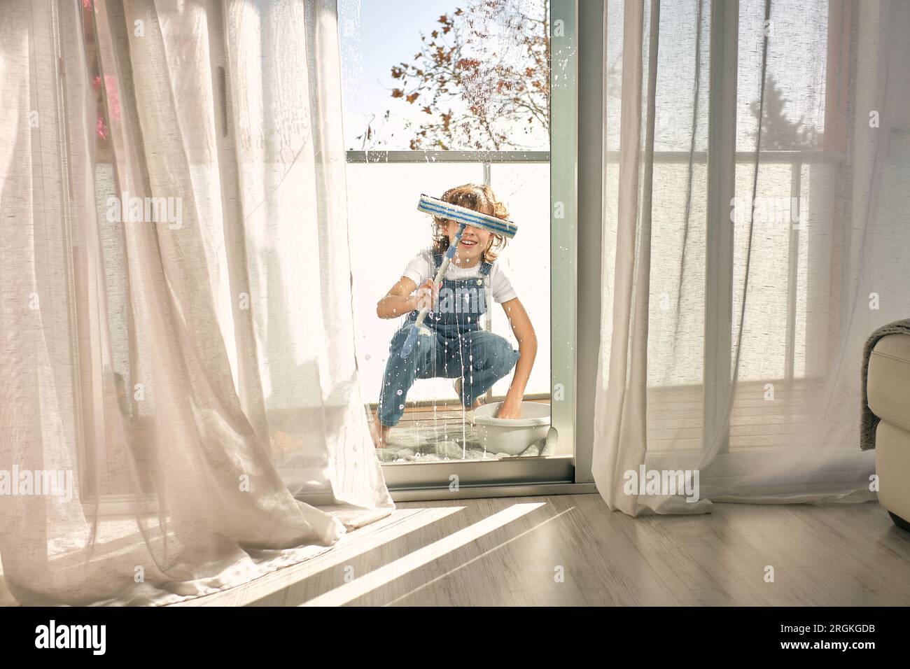 Full length of smiling boy in casual clothes crouching while doing ...