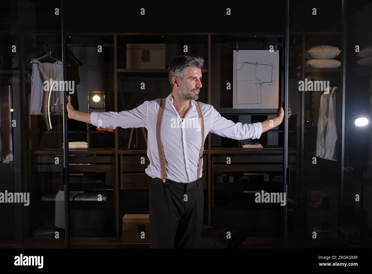 Grey haired bearded man in classic shirt and trousers standing at ...