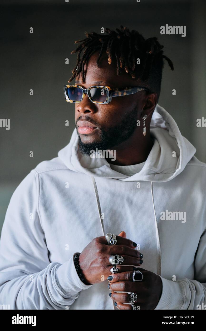 Serious black male model with dreadlocks wearing stylish hoodie and ...