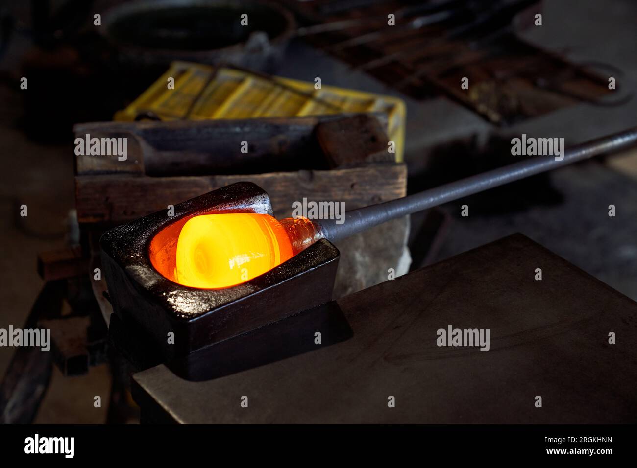 High angle of burning glass being shaped before being blown in glass ...