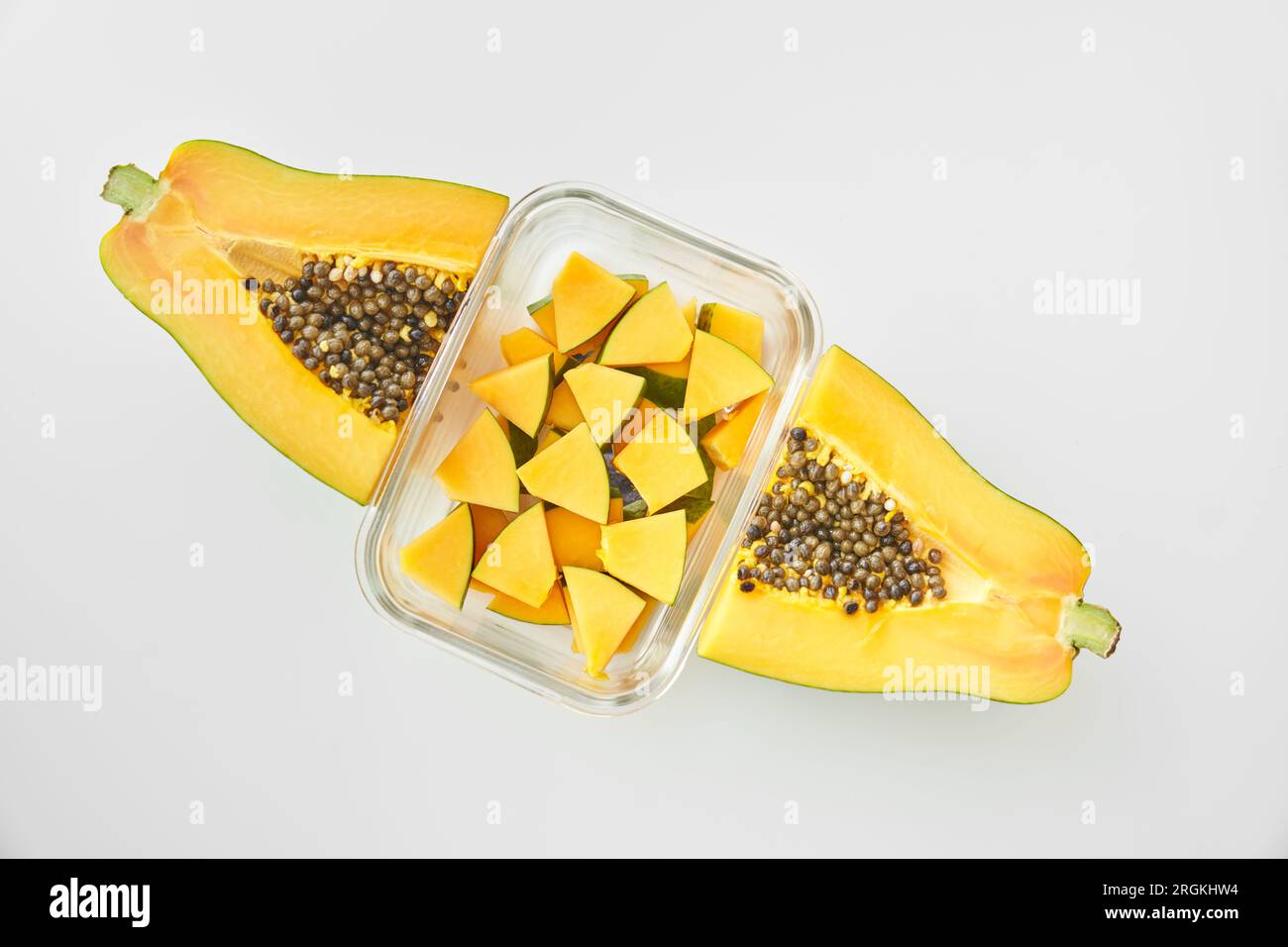 Top view of pile of ripe papaya cubes placed in glass container between ...