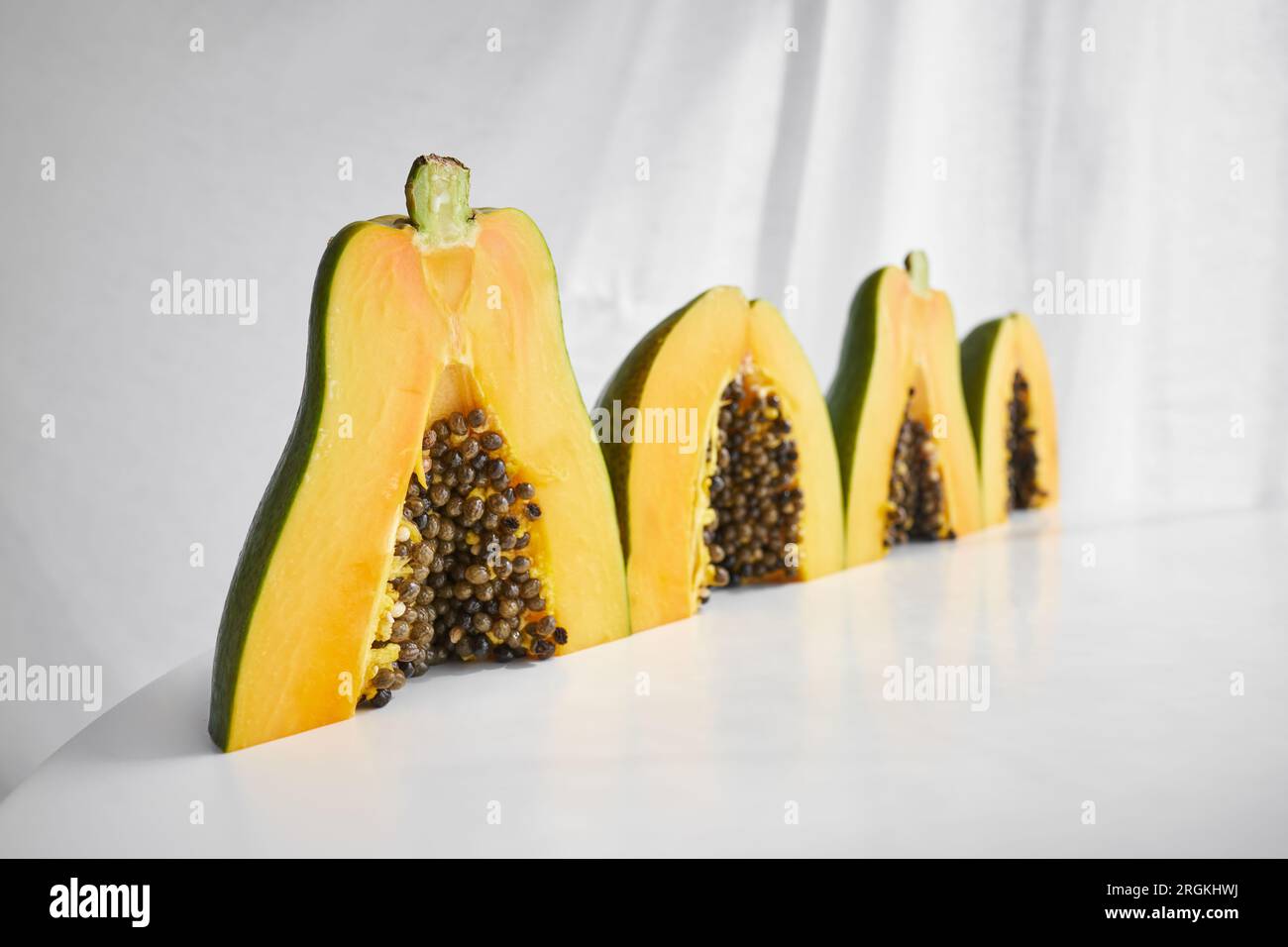 Side view of bunch of delicious ripe fresh papaya fruit cut into pieces ...