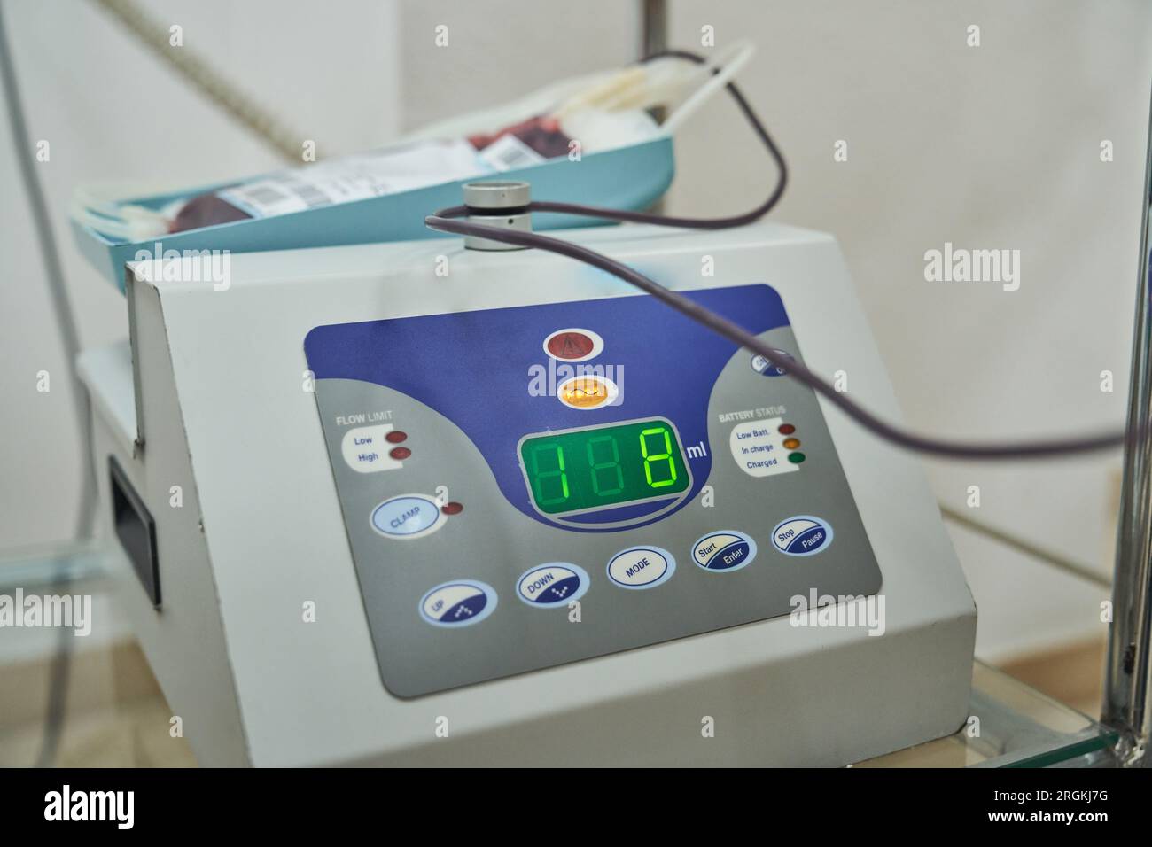 Modern blood collection monitor machine placed on glass shelf in ...