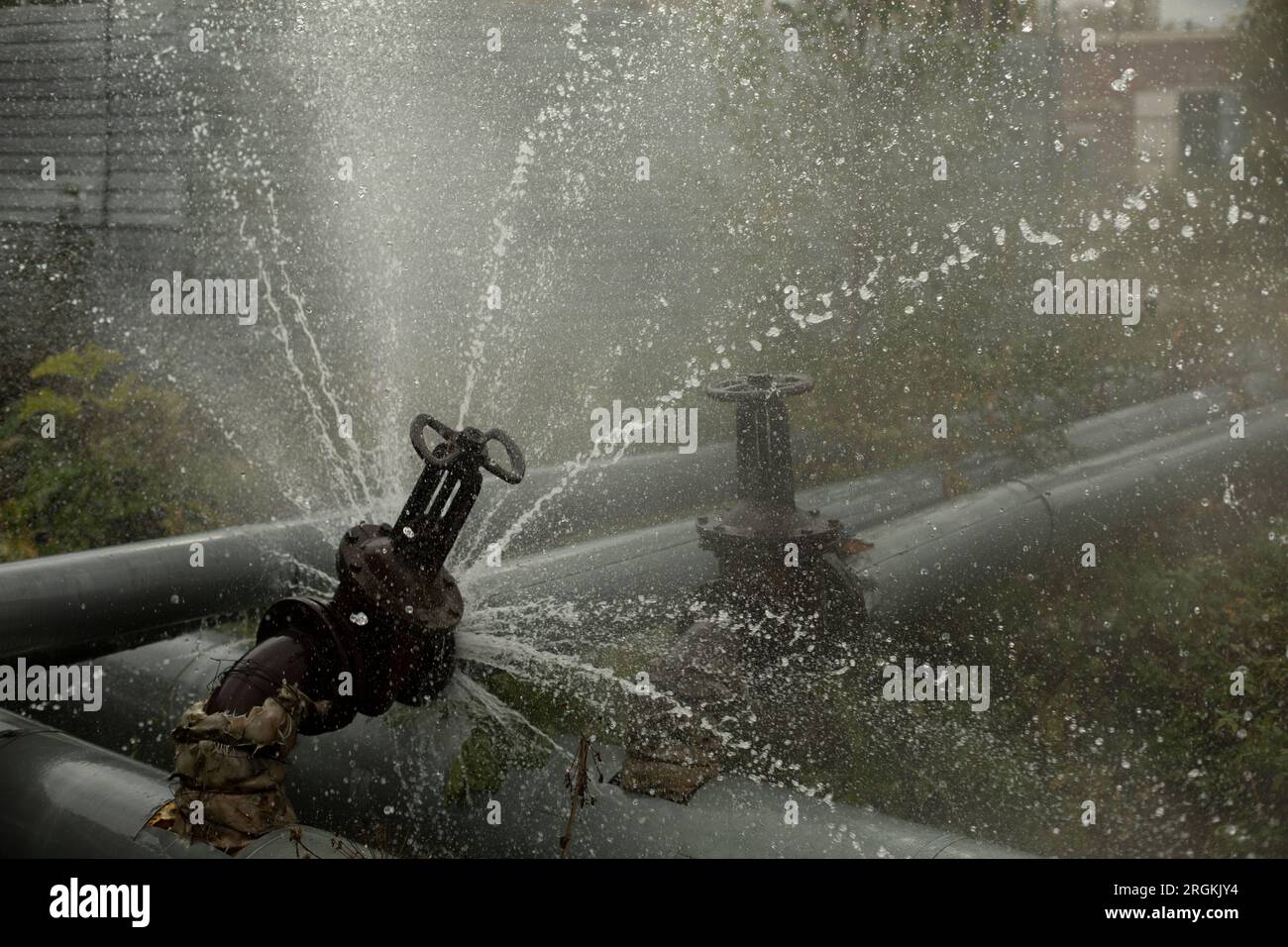 Valve on tube. Torn pipe valve. Boiling water pours from pipeline ...