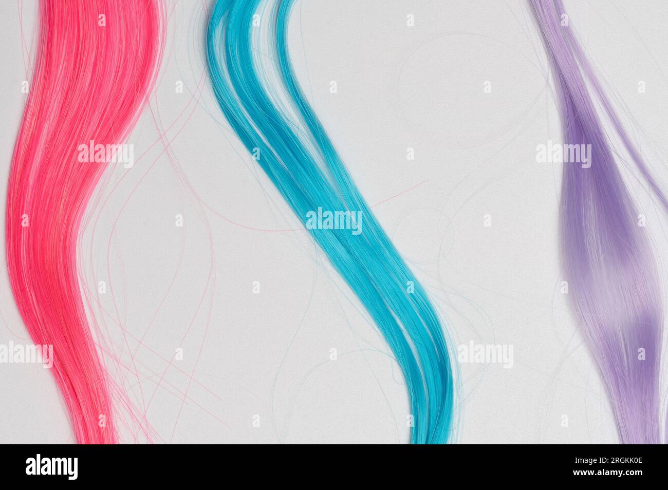 Three colorful hair strands isolated on white studio background Stock ...