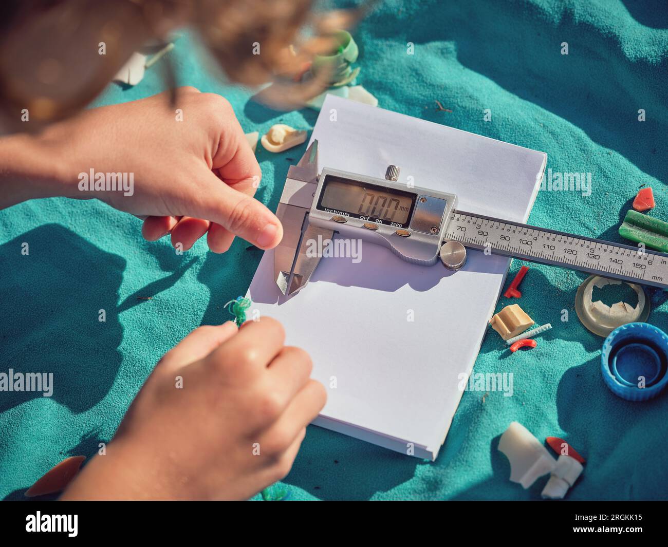 Overhead of crop preteen boy preparing measuring of small piece of ...