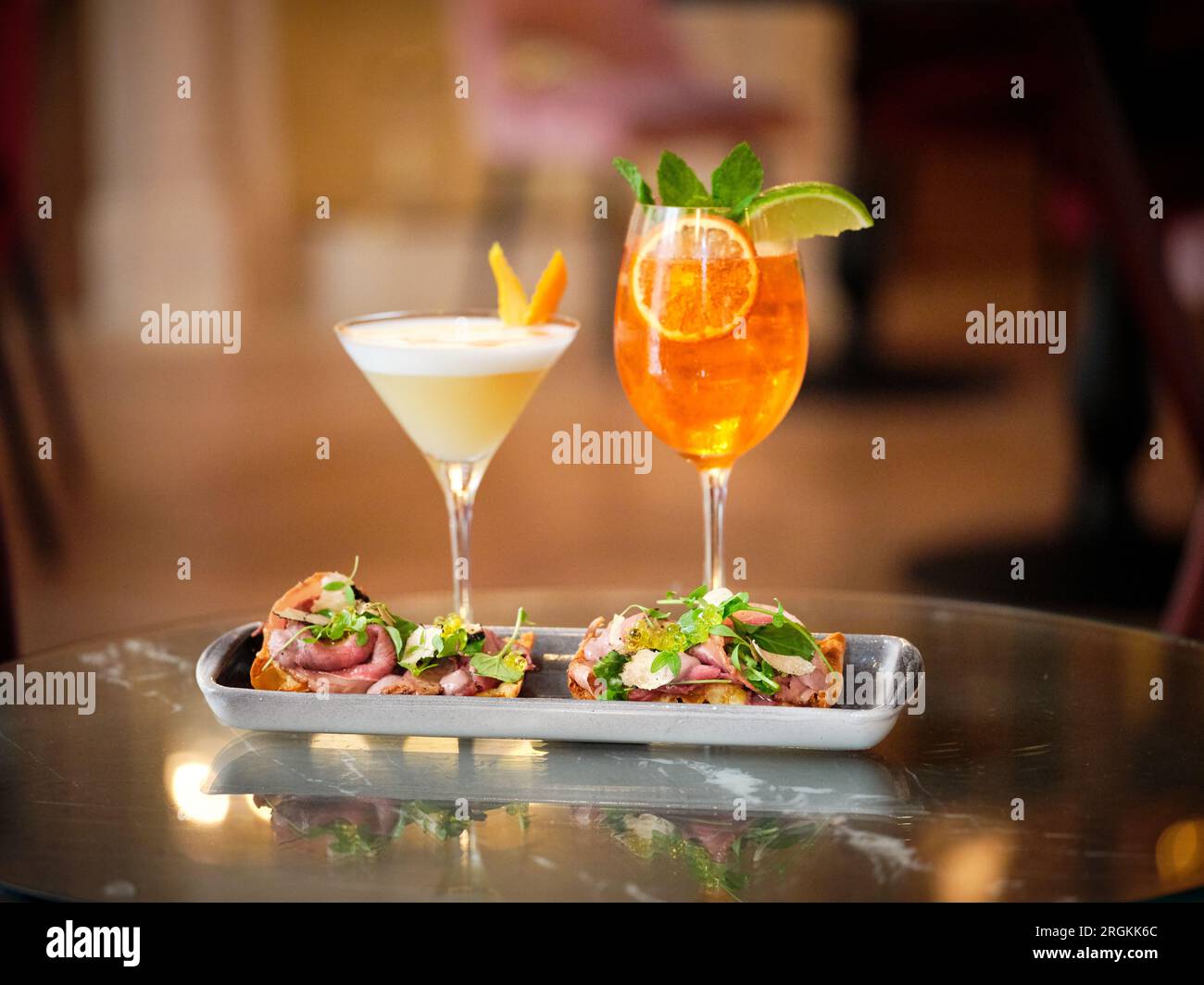 Restaurant presenting set of aperitif cocktails and snacks on table on ...