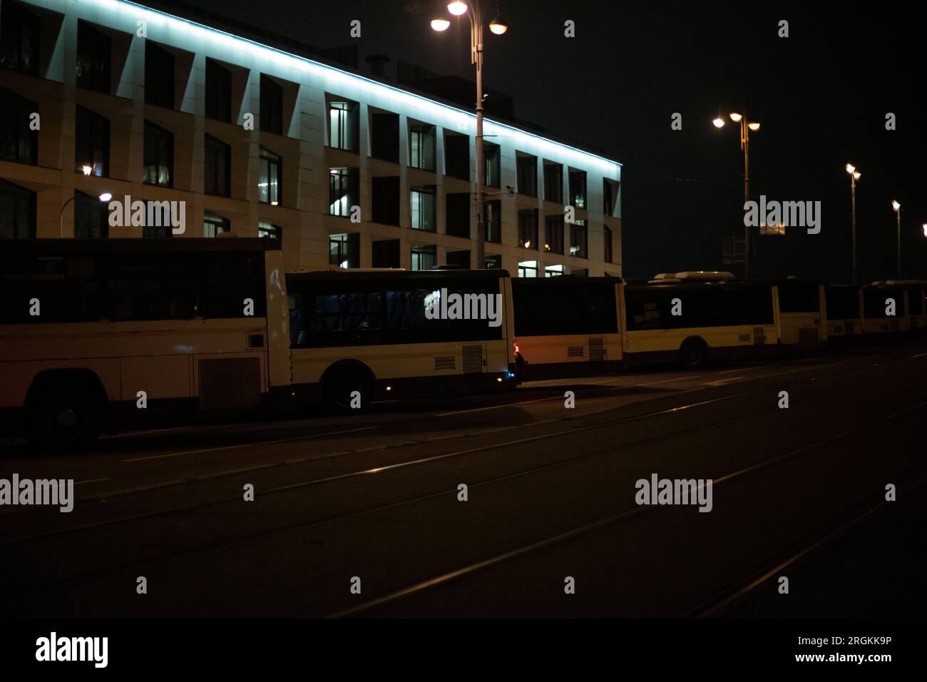 Buses at night in parking lot. City in evening. Parking for public ...