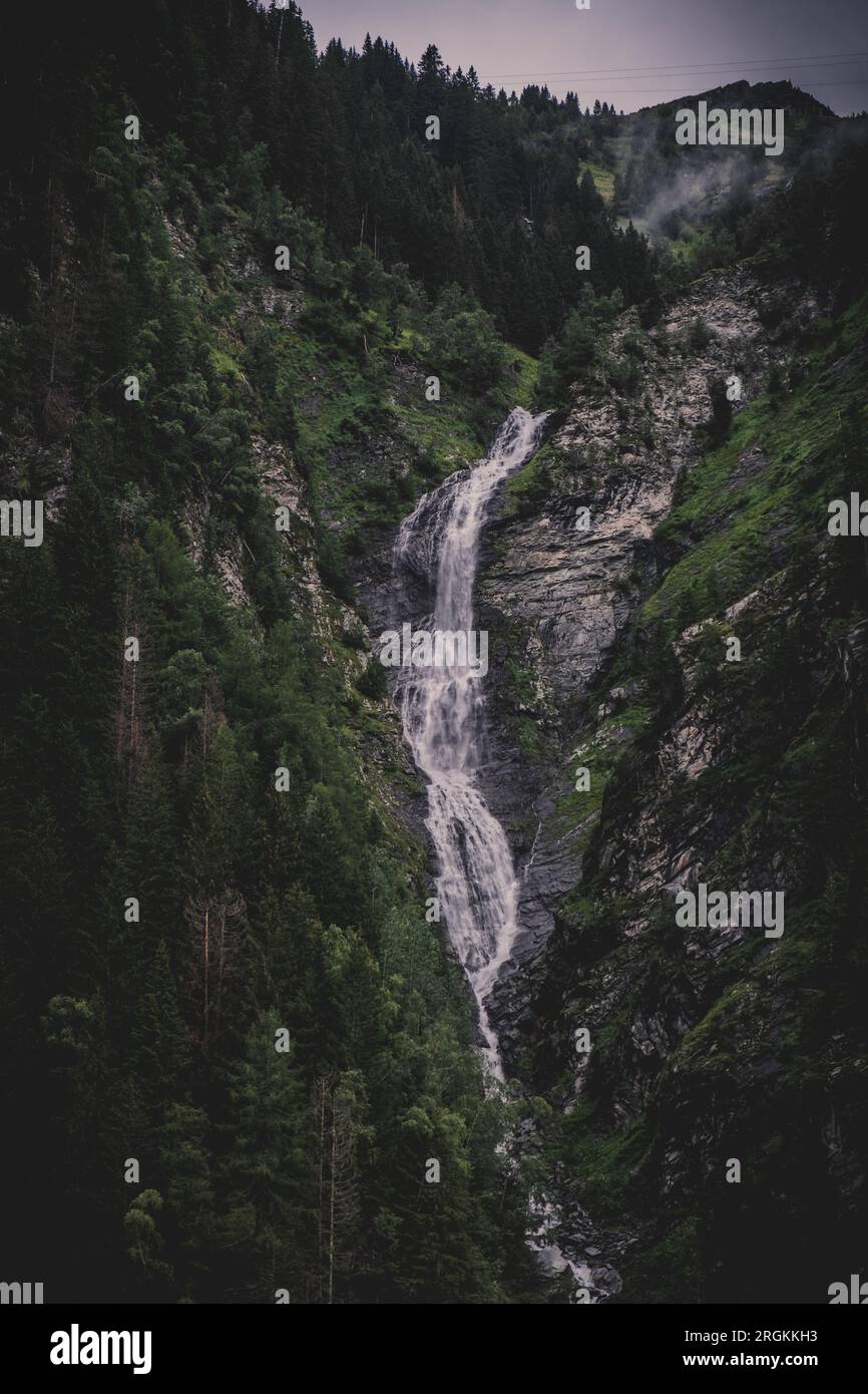 A Beautiful waterfall between the mountains, background, River between ...