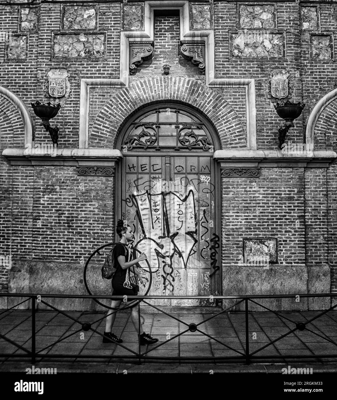 Passerby carrying wheel on the streets of Madrid. Spain Stock Photo - Alamy