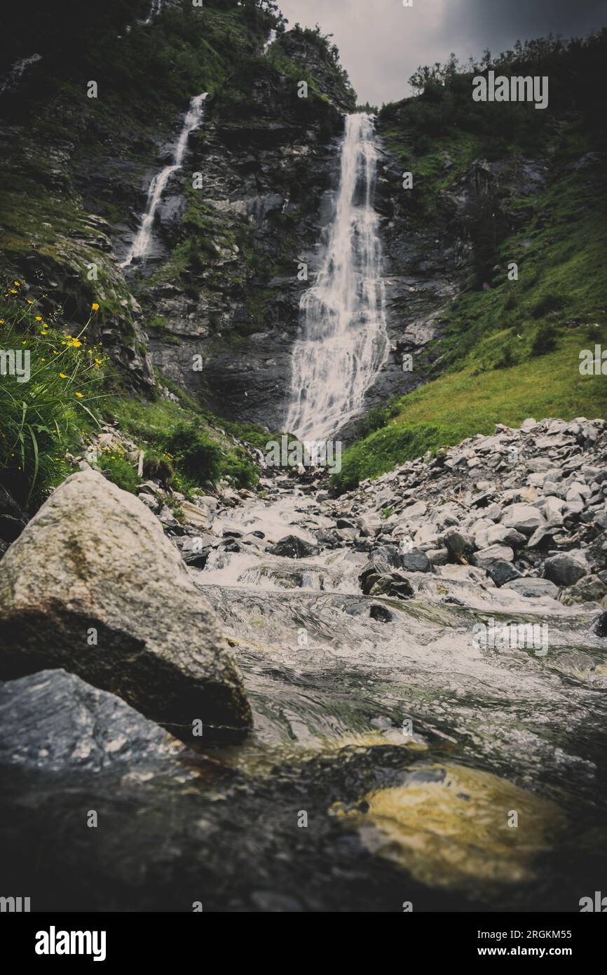 A Beautiful waterfall between the mountains, background, River between ...