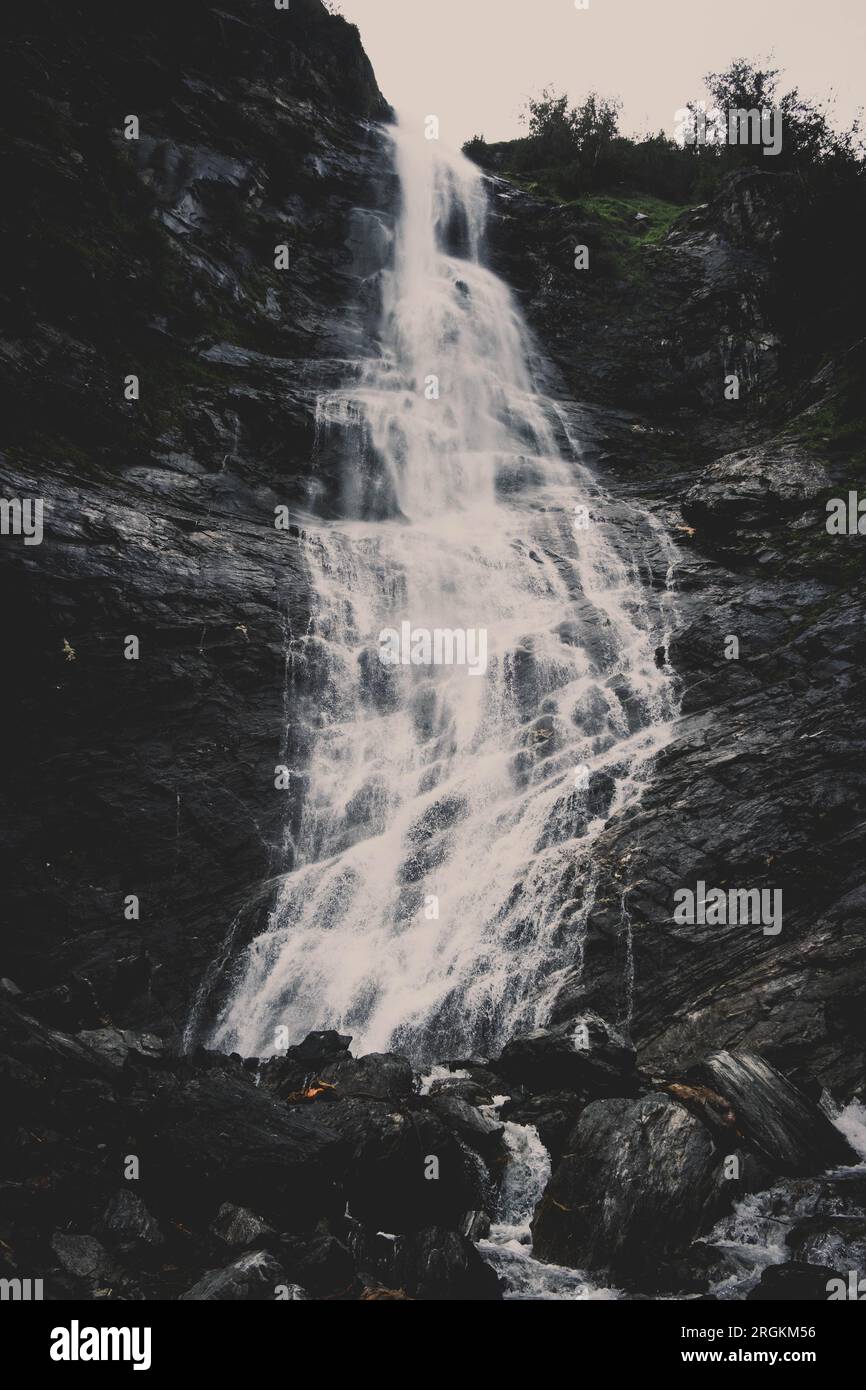 A Beautiful waterfall between the mountains, background, River between ...
