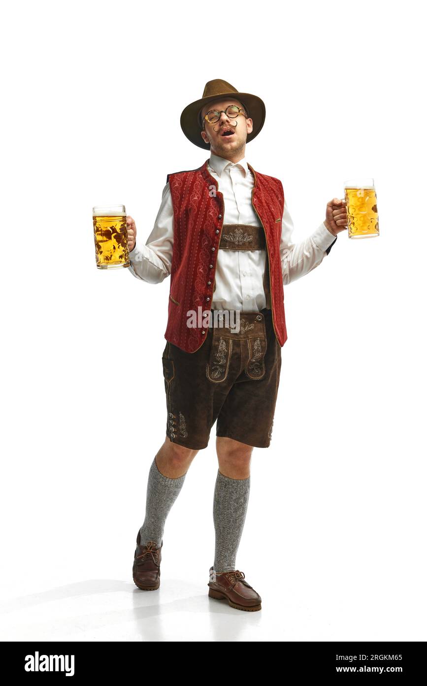 Young attractive mustache man in hat, wearing folk Bavarian outfit ...