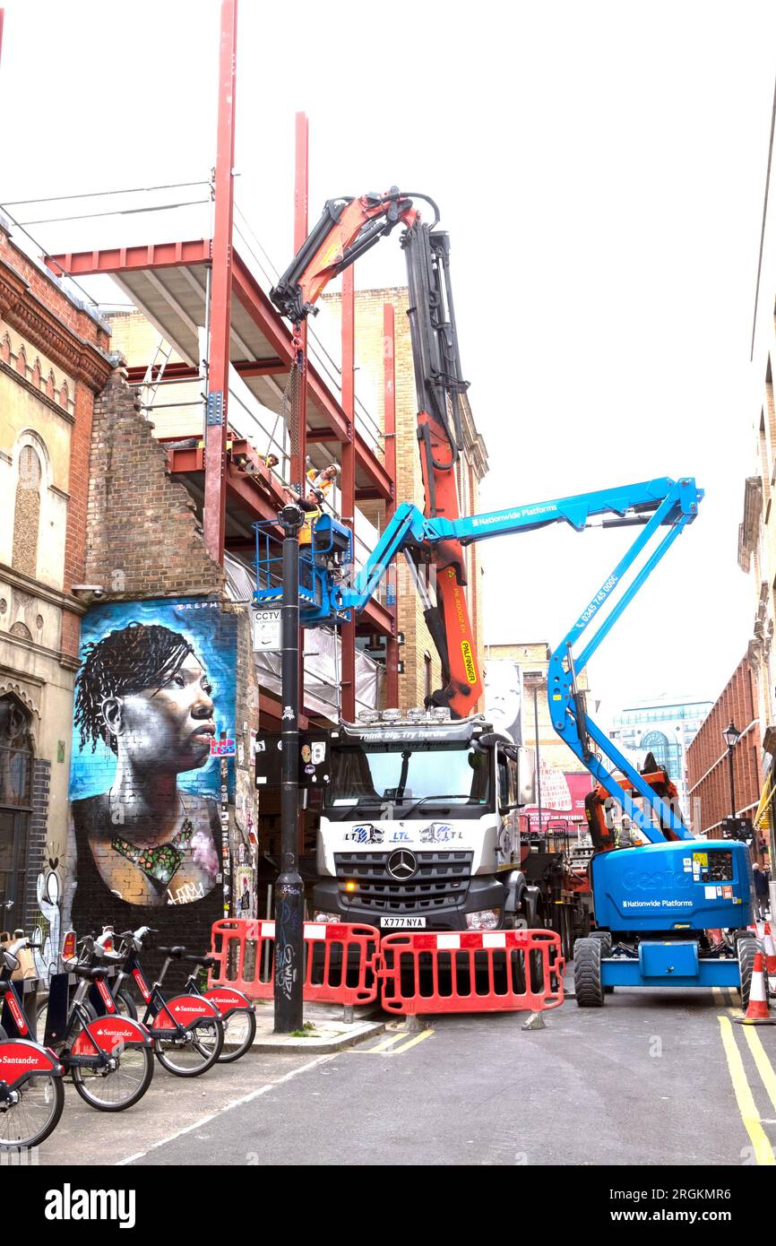 Road closed blocked by construction lorry with crane and cherry picker ...