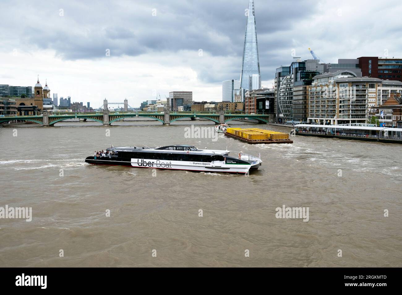 Uber boat Thames clipper people tourists and view of Shard building and ...
