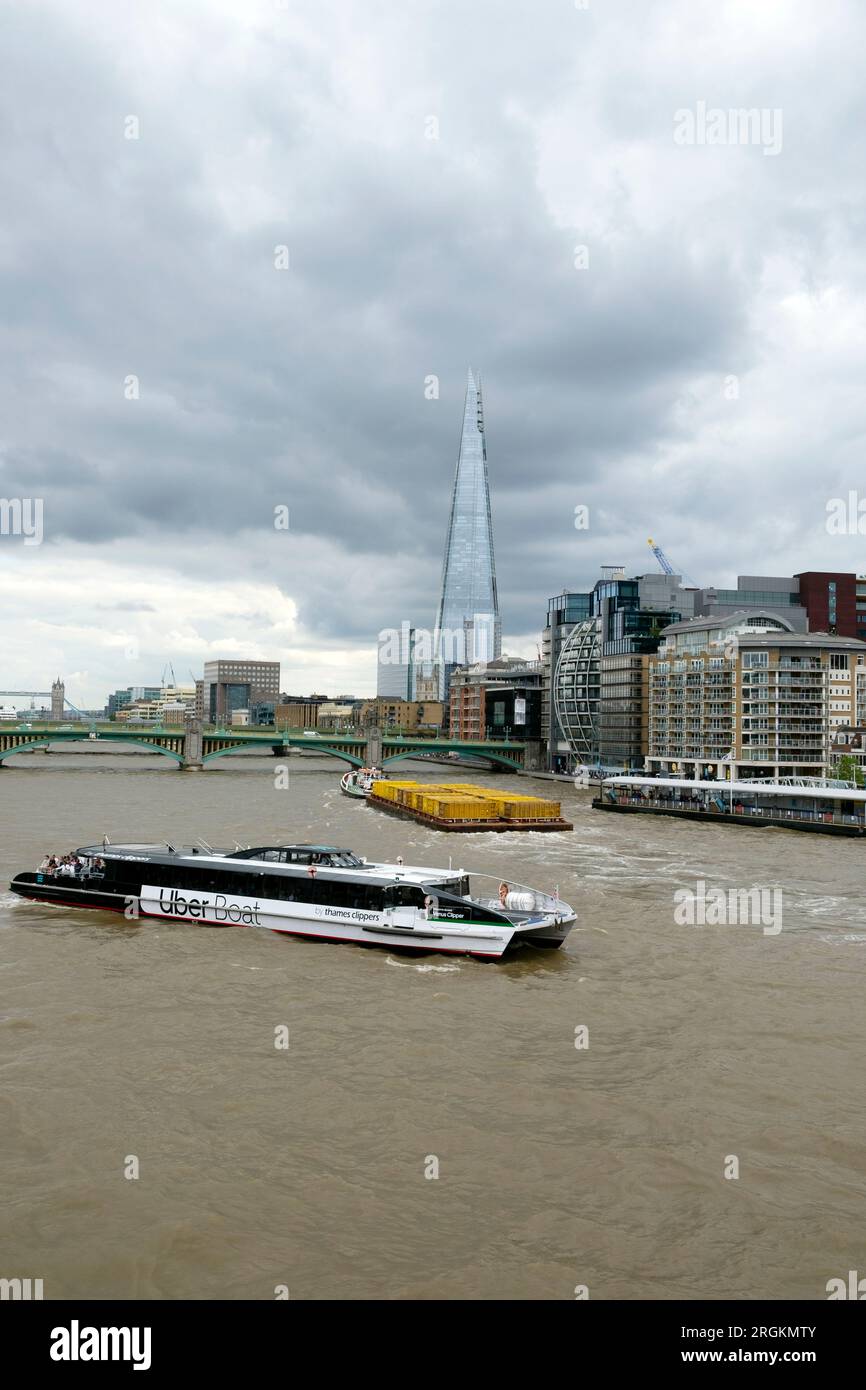 Uber boat Thames clipper people tourists and view of Shard building and ...