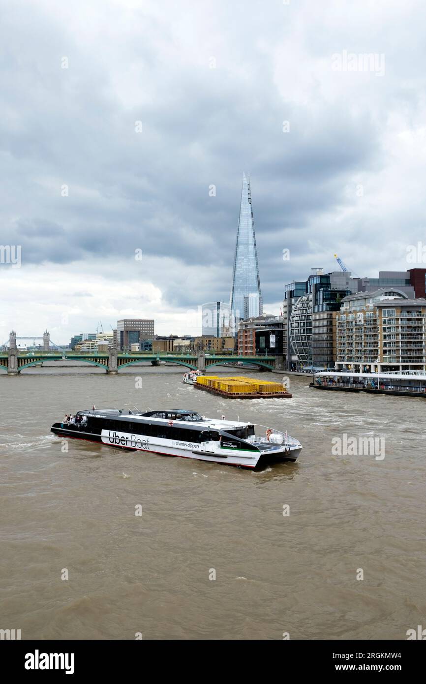 Uber boat Thames clipper people tourists and view of Shard building and ...