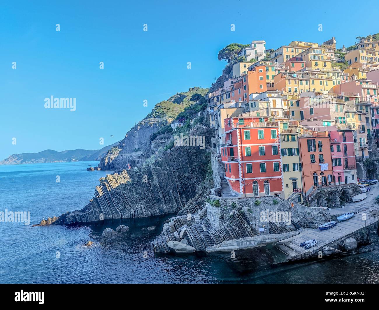 Aerial panoramic view of Riomaggiore town with many colorful houses and ...