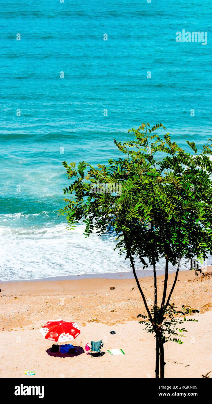 Camping chair with red umbrella on the beach with blue sea day noon ...