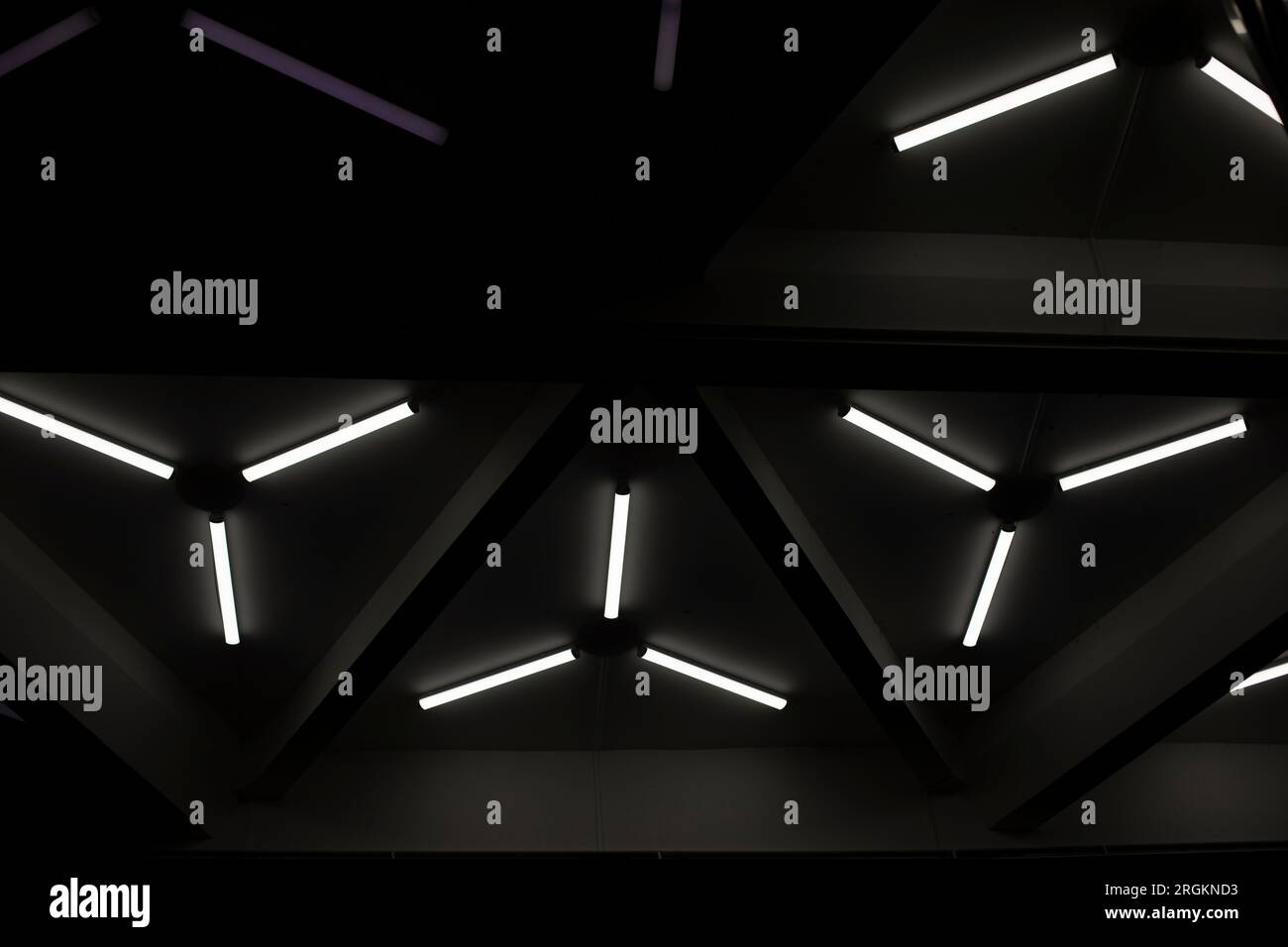 Triangular fluorescent lamps. Ceiling design. Interior details ...