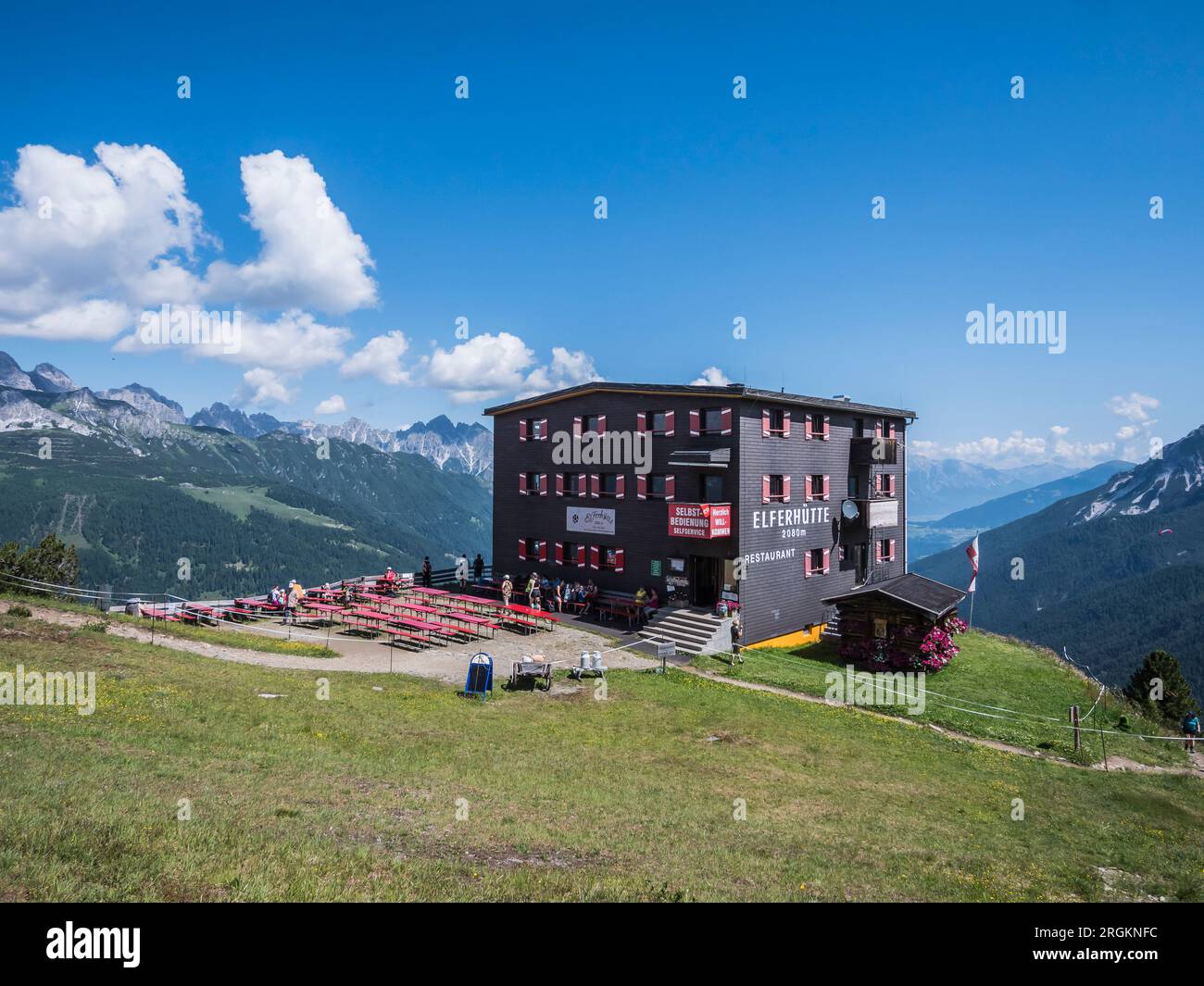 The image is of the Elfer Hut mountain refuge located near the Elfer ...