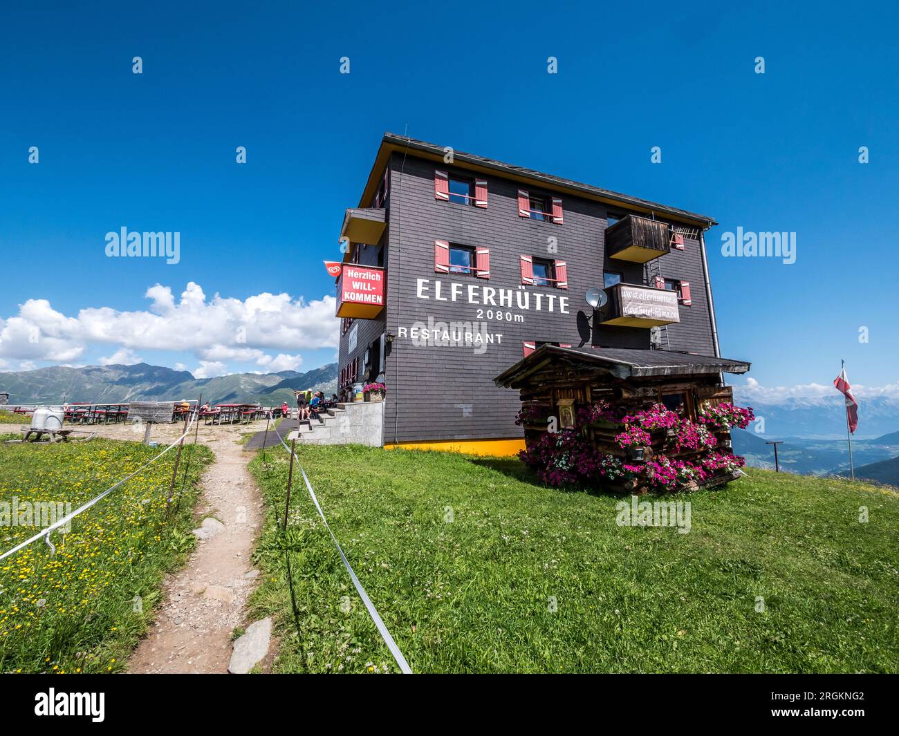 The image is of the Elfer Hut mountain refuge located near the Elfer ...
