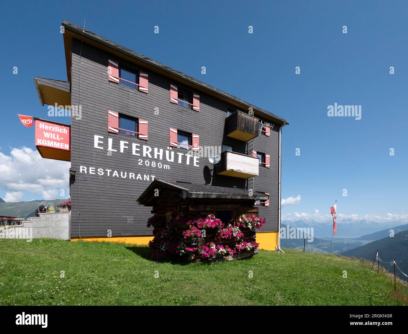 The image is of the Elfer Hut mountain refuge located near the Elfer ...