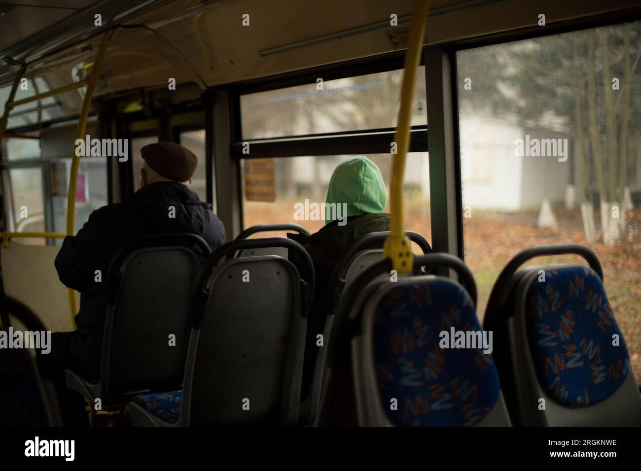 People on bus. Passengers sit on seats in transport. Inside public ...