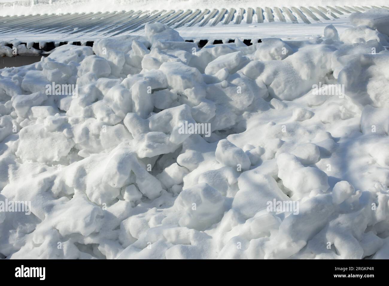 Snow on roof. Snow removal from roof of house. Large clumps of ice ...