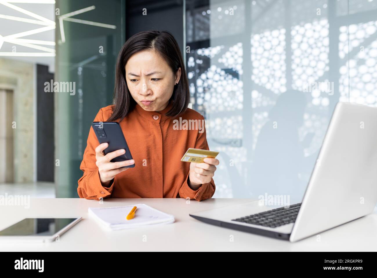 Upset and disappointed woman inside office at workplace, cheated asian ...