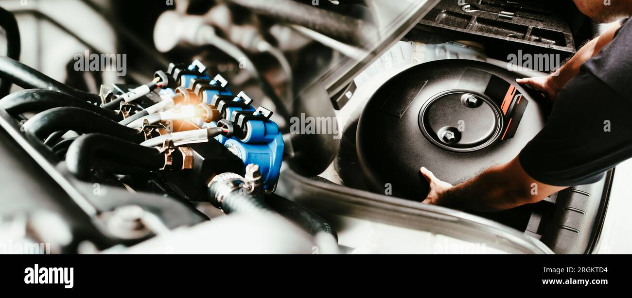 A mechanic is installing a car circle-shaped LPG or Propane tank in a ...