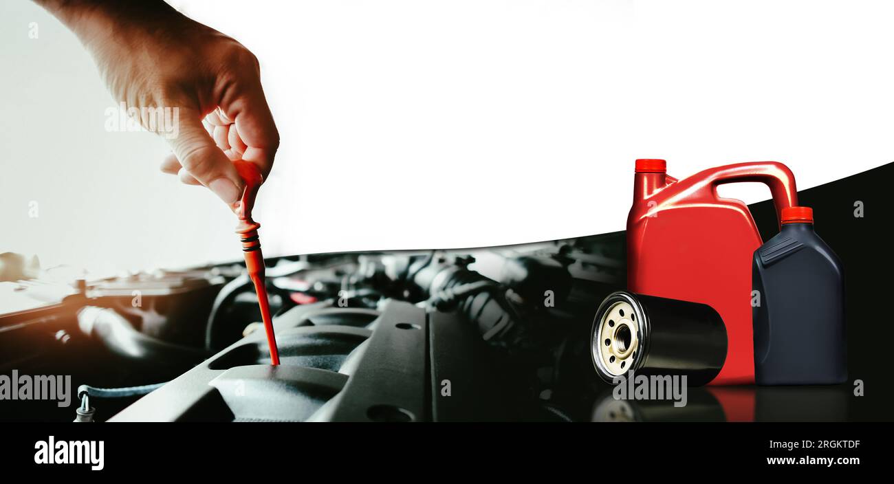 The mechanic is pulling the motor oil dipstick in the engine ...