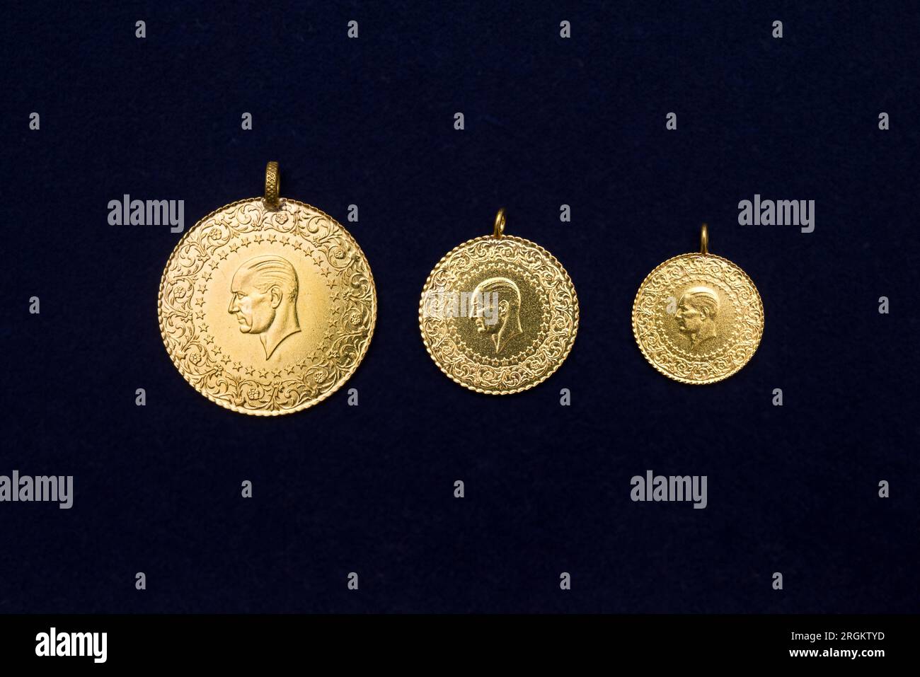 full, half and quarter Turkish gold coins side by side on a dark navy ...