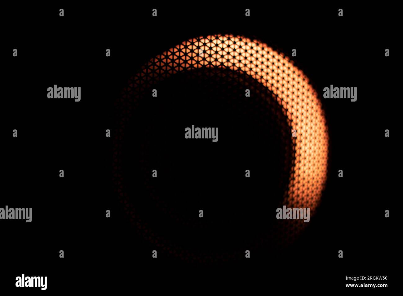 Orange light in dark. Glow through grid. Dots on black background ...