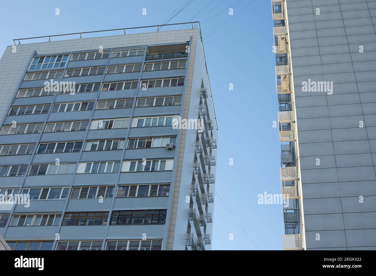 Grey building in city. High house. Windows in residential building ...
