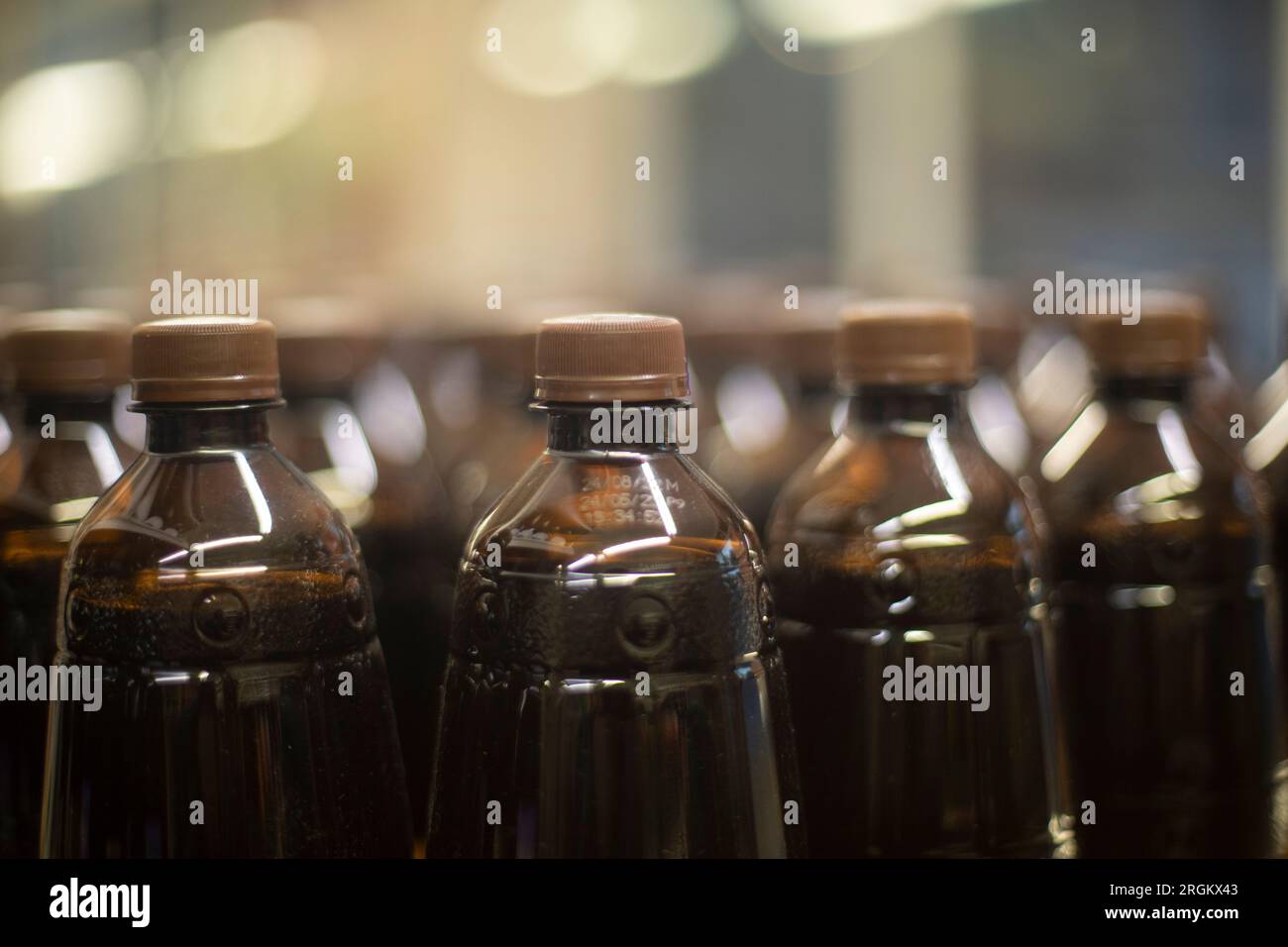 Bottles of carbonated drink in supermarket. Water in stock. Plastic ...