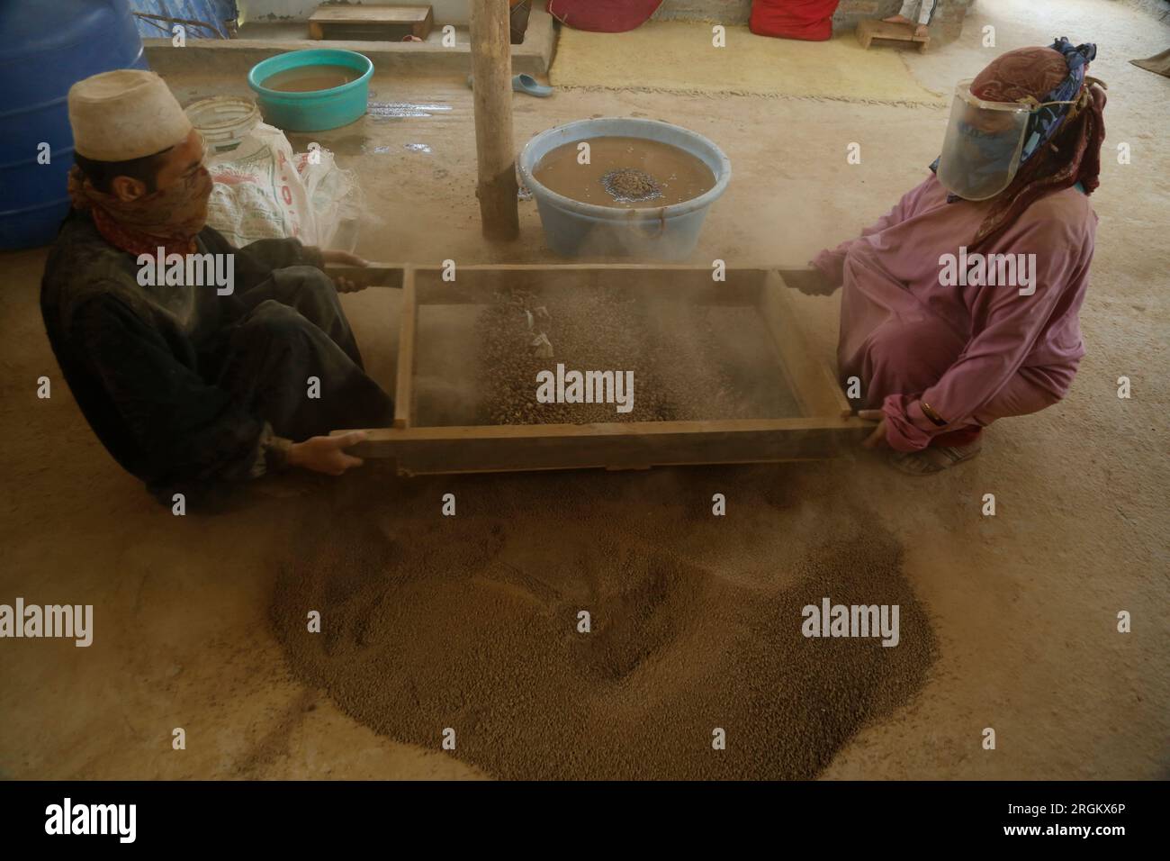 August 10,2023, Srinagar Kashmir, India : Kashmiri Potter cleaning clay ...