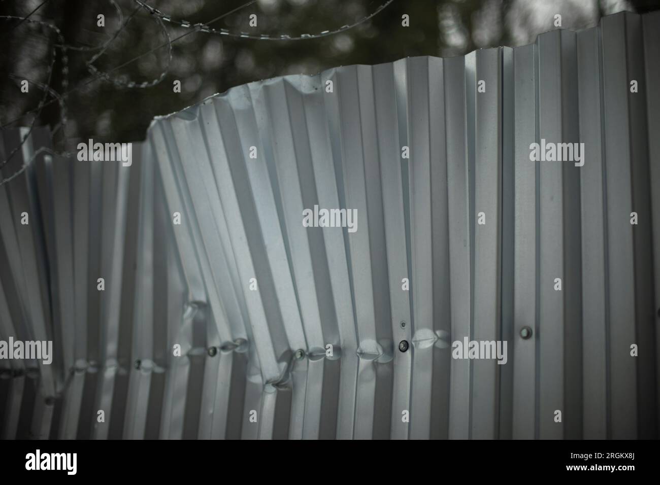 Steel fence. Broken fence. Crumpled metal profile. Metal damage Stock ...
