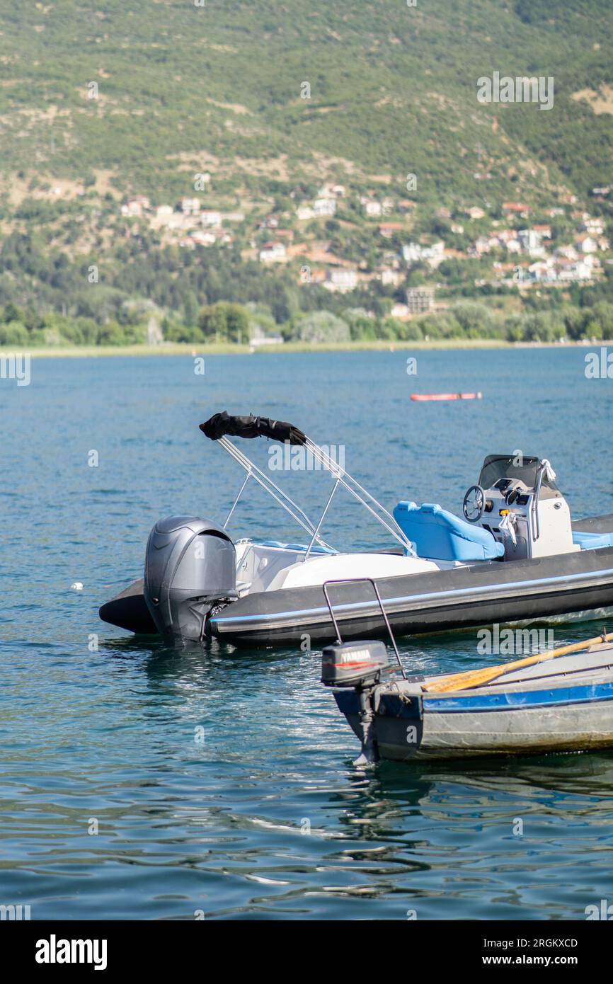 A modern and old boat with engine in a lake on sunny day Stock Photo ...