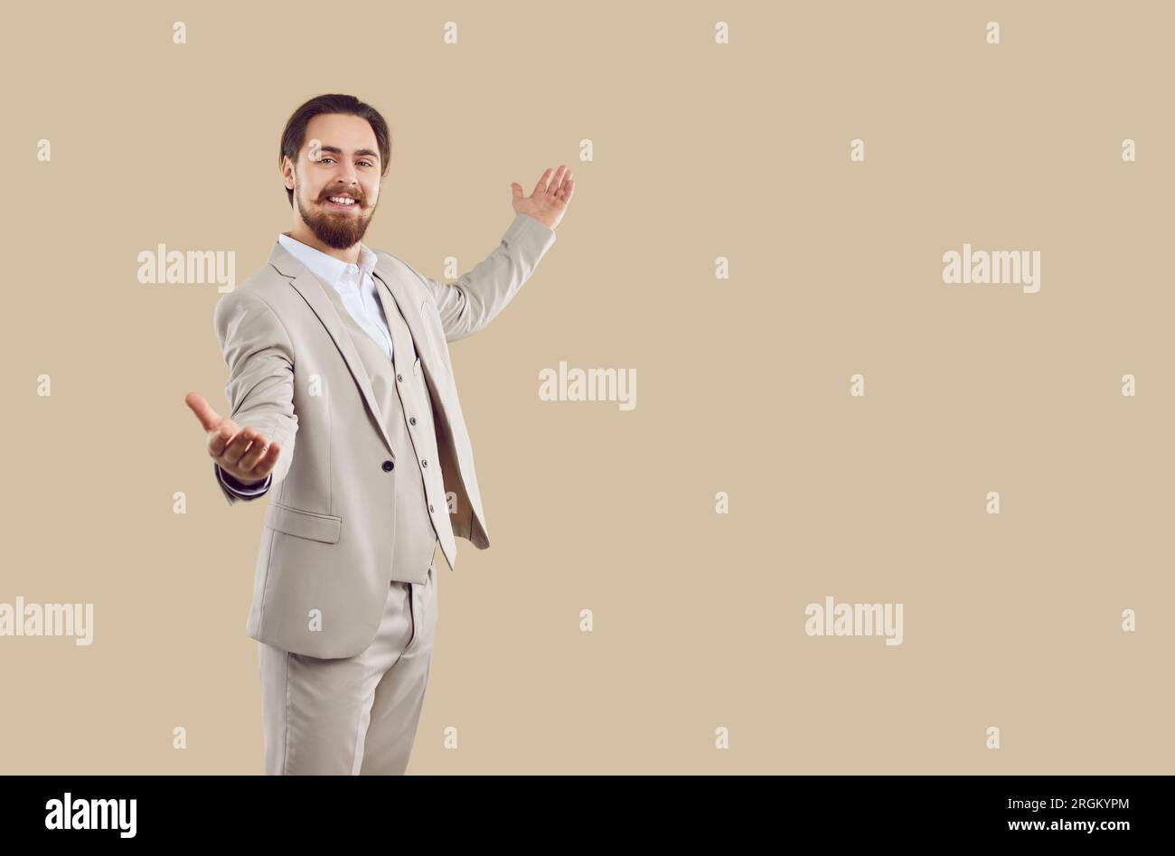 Happy man inviting to business event and showing something on beige ...