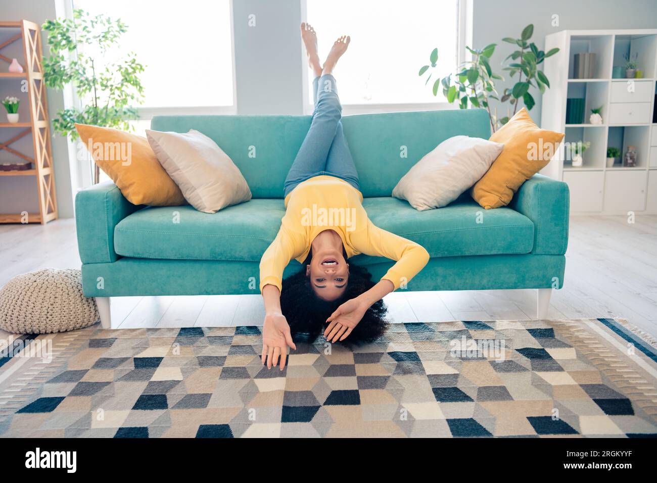 Full length photo of overjoyed pretty cheerful person sit couch upside ...