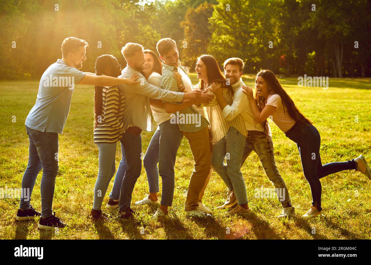 Funny happy overjoyed group of people friends having fun in nature on ...