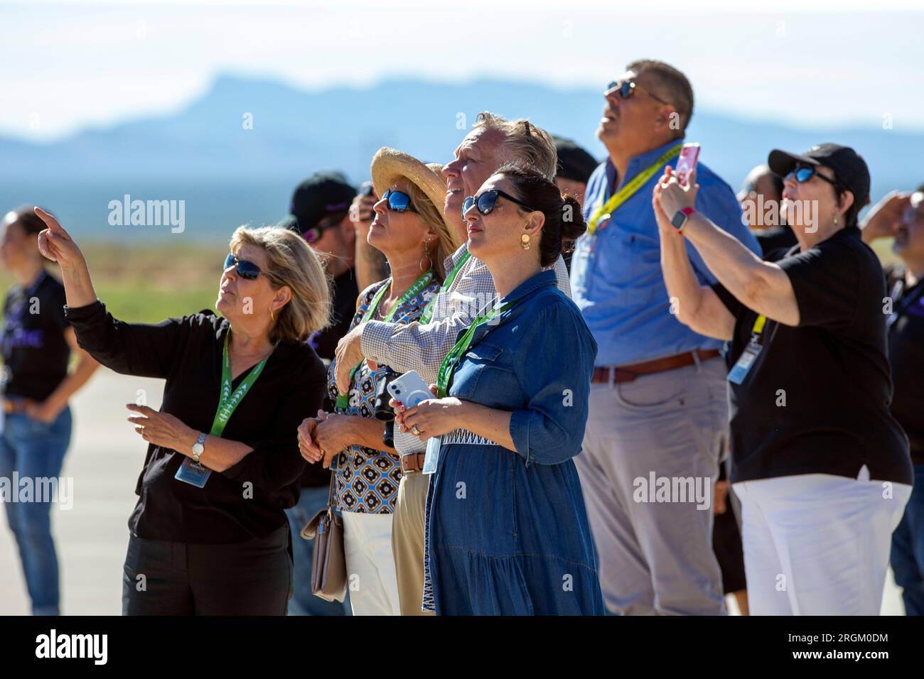 Guests watch as Virgin Galactic's mothership Eve, carrying the rocket ...