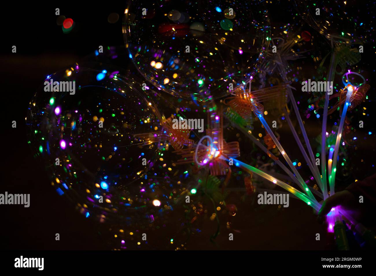 Colored balls in dark. LED Light. Transparent ball with colored lights ...