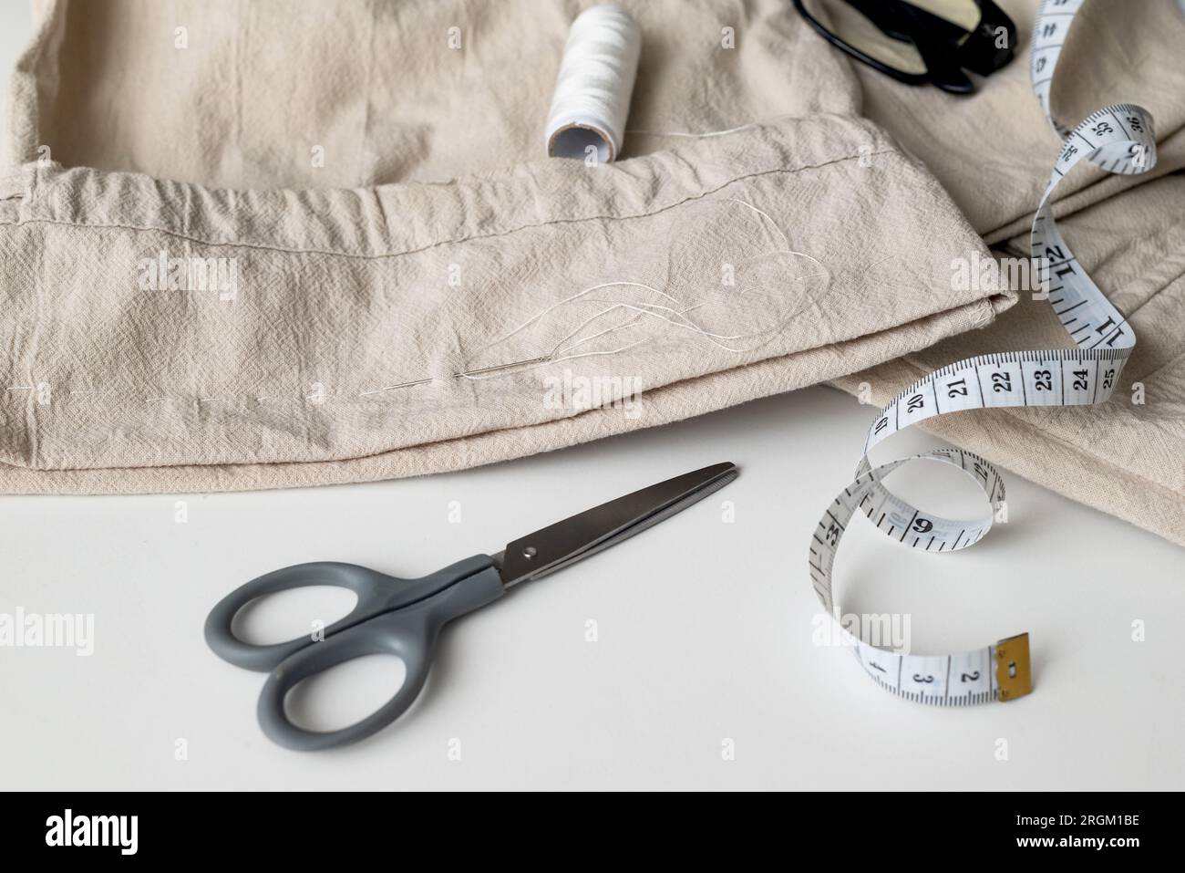 linen trousers with tools to repair old clothes. Sewing and home ...