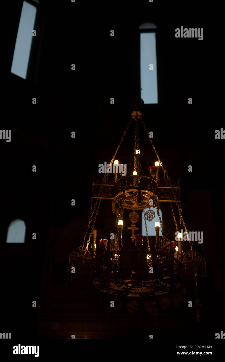 Interior of temple. Antique chandelier. Windows in dark. Lighting in ...
